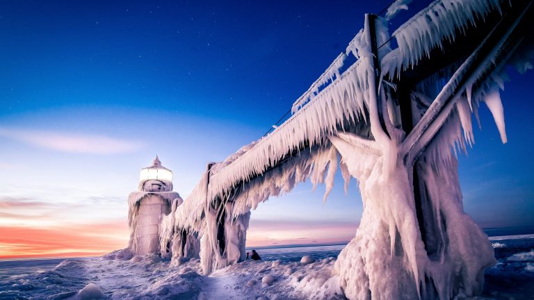 Ice covered St. Joseph north pier lighthouse in winter, Michigan, USA ...