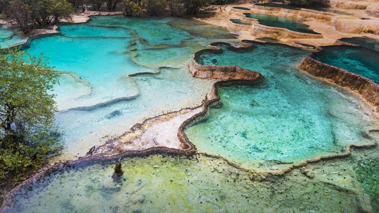 Colourful pools formed by calcite deposits, Huanglong, Sichuan province ...