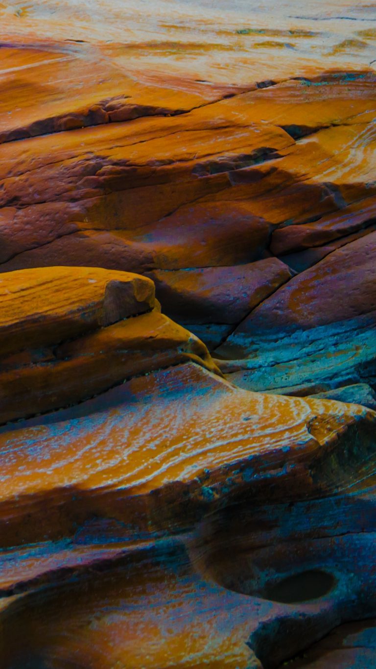 Brightly coloured rock on a beach in Maryport, Cumbria, England, UK ...