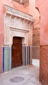 Door decorated by carved stucco on a hidden alley in the old Medina of ...